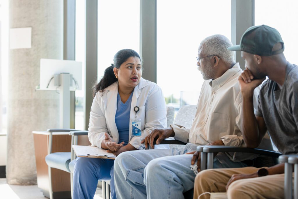 Senior man and his son listen to female doctor | Texas Medical Institute